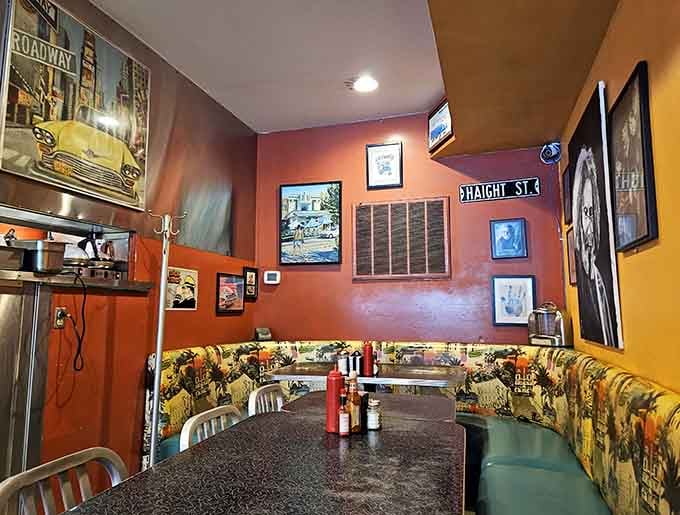 Colorful walls adorned with vintage artwork create a dining space that's equal parts nostalgia and welcoming warmth.