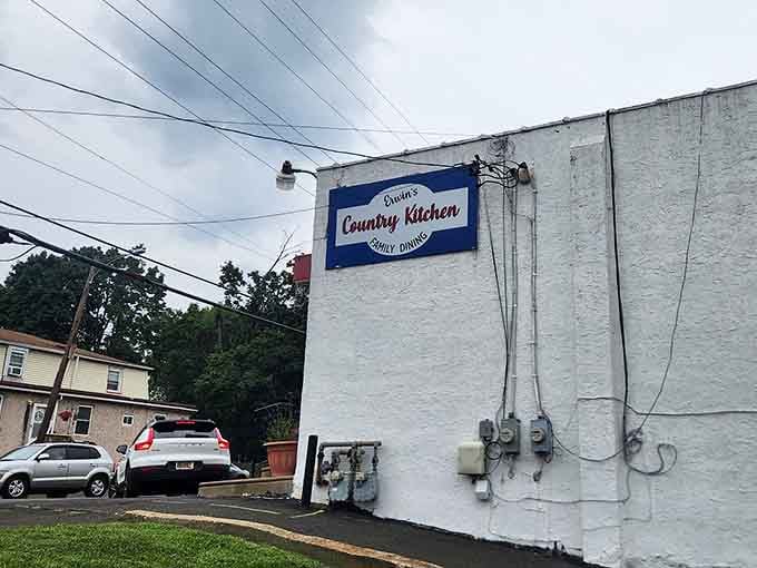 The exterior's simple white walls hide the enchanting European experience waiting just beyond those wooden doors.