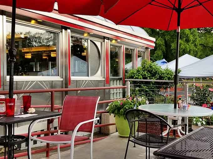 Outdoor seating with red umbrellas lets you enjoy your meal al fresco while pretending you're somewhere fancier than Route 9.