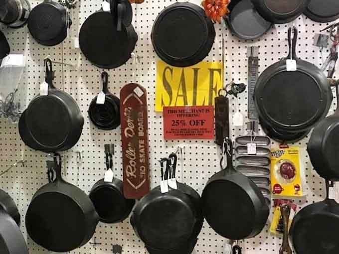 Cast iron skillets hanging like a Southern kitchen's greatest hits album, seasoned with decades of stories.