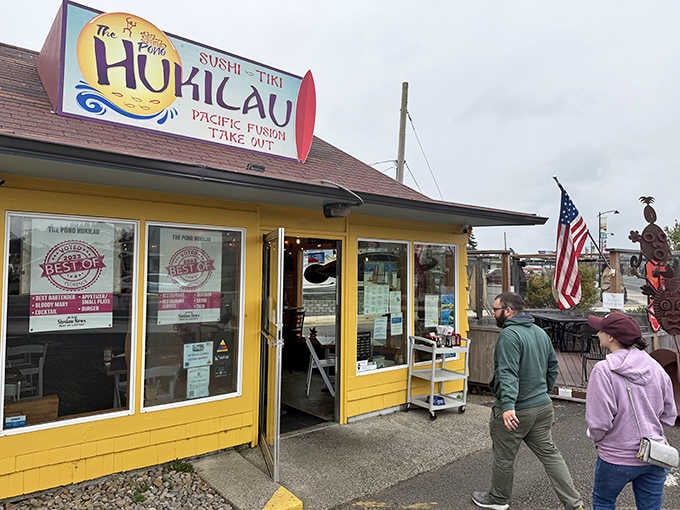 The Pono Hukilau's cheerful yellow exterior promises Pacific fusion flavors that'll transport your taste buds straight to the islands.