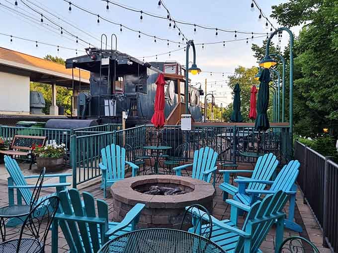 Outdoor patio with fire pit and string lights, perfect for summer evenings when beer tastes even better.