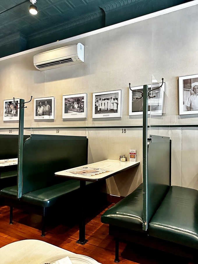 Numbered booths lined with vintage photographs remind you that countless families have shared meals in these exact same spots.