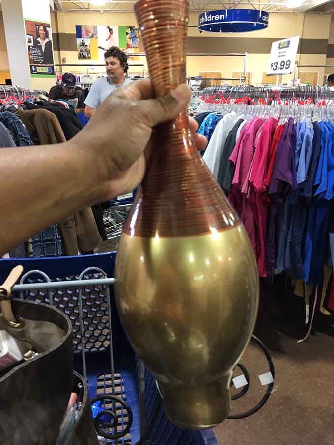 Someone's holding what might be the world's most interesting vase, proving treasure hunting here yields unexpected golden finds.