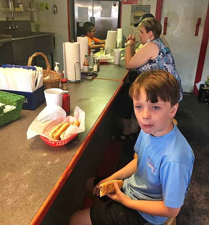 Generations gathering at the counter, proving great food brings everyone together regardless of age.