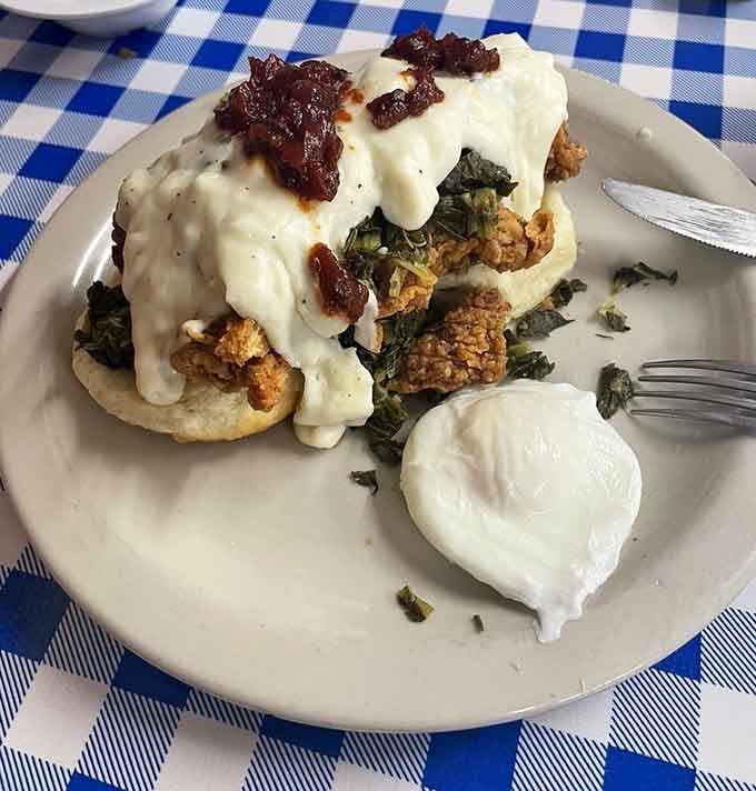 The Red Dog piles fried chicken, collards, and gravy on a biscuit, creating edible architecture worth photographing.