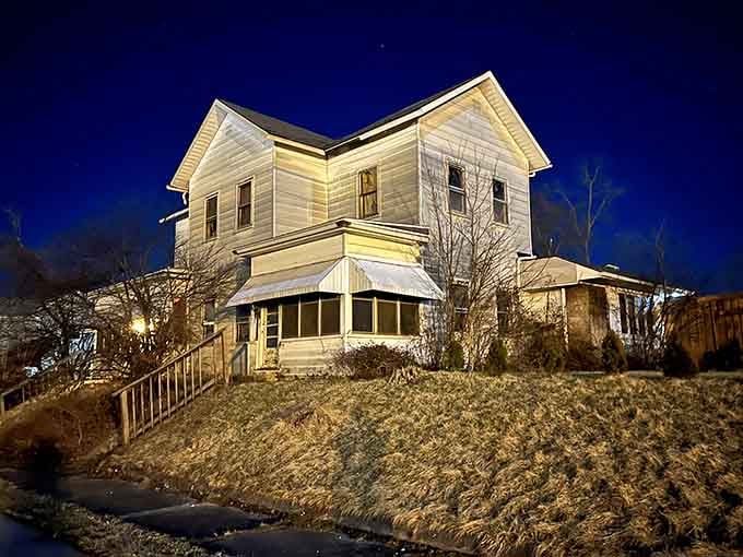 This illuminated Victorian beauty glowing against twilight sky, proving Hartford City's historic homes have serious curb appeal and character.