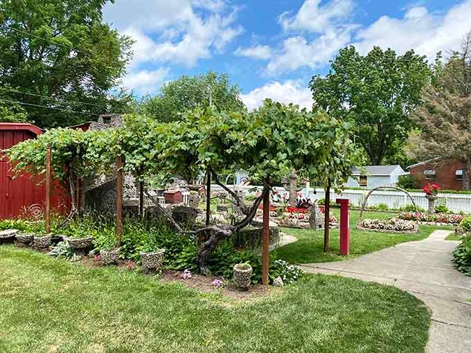 Grape arbors provide natural shade over the pathways, proving even practical elements get the decorative stone treatment here in Springfield.