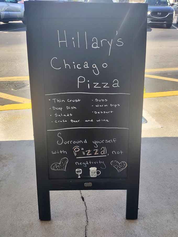 Sidewalk sign with charming handwritten wisdom reminding you to surround yourself with pizza, not negativity ever.