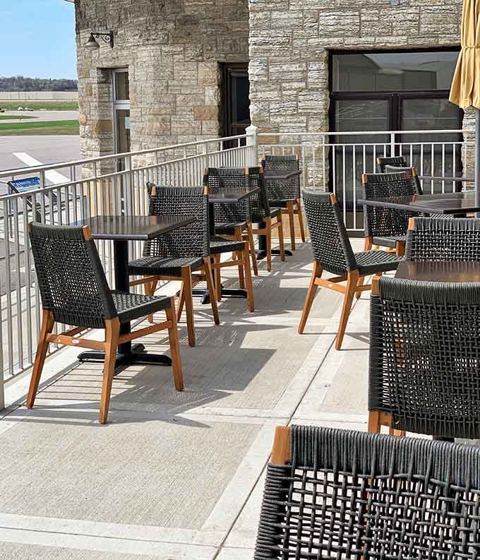 Outdoor patio seating with unexpected runway views adds a whole new dimension to the dining experience here.