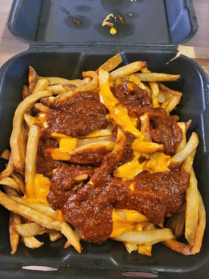 Chili cheese fries in a to-go container, because sometimes happiness needs to travel with you on the road.