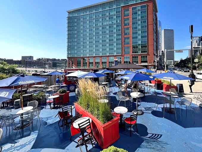 Waterfront patio seating with umbrellas and a view&mdash;eating lobster while overlooking the channel is peak Boston living.