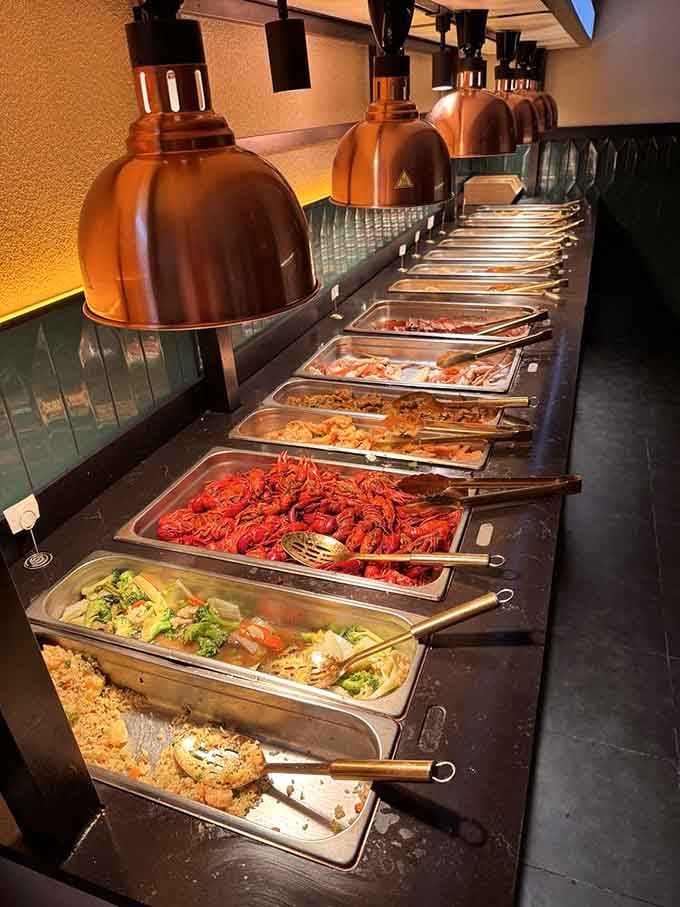 Endless buffet trays glow under warm lights, making abundance feel less like excess and more like an invitation.