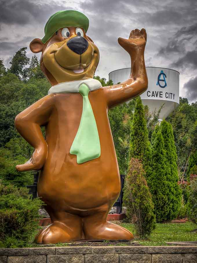 Yogi's cheerful wave greets visitors to Cave City, gateway to underground wonders and roadside Americana charm.