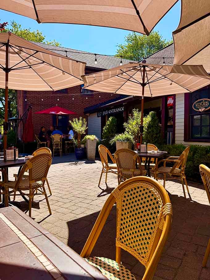 Umbrella-shaded patio seating where blue skies and good coffee make ordinary mornings feel like mini vacations.