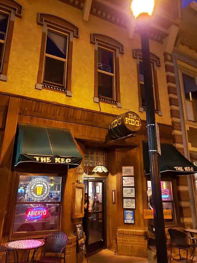 The entrance at night looks inviting with warm lighting that practically pulls you off the street and inside.