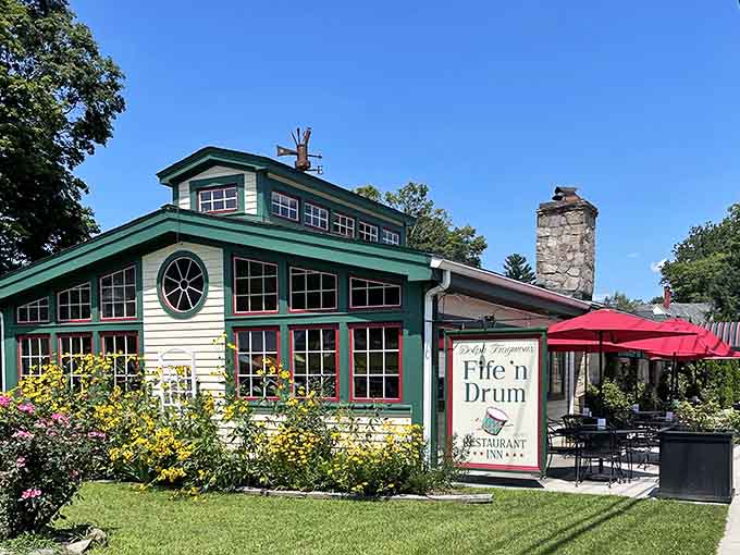 The Fife 'n Drum sits pretty with its green trim and red umbrellas, looking exactly like a restaurant should.