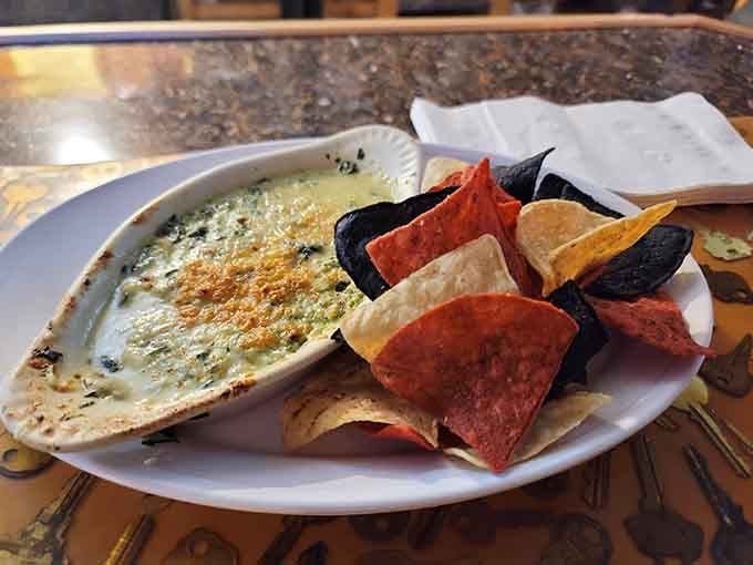 Spinach dip with tri-color chips: the appetizer that disappears faster than your resolve to save room for dinner.