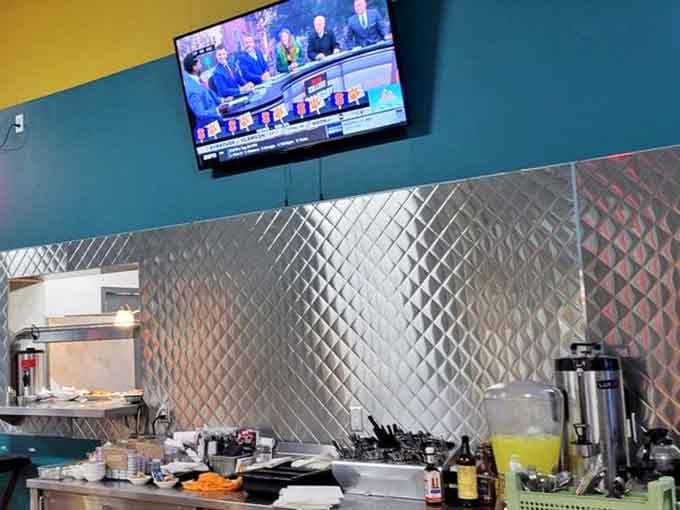 The kitchen prep area gleams with stainless steel efficiency, where breakfast dreams transform into delicious reality every single morning here.