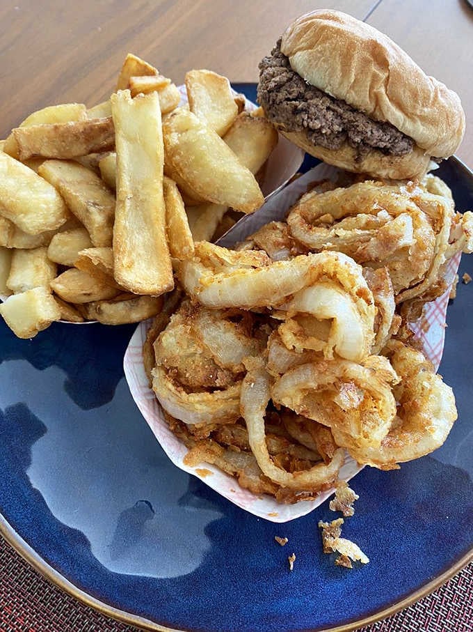 Golden fries, crispy onion rings, and a burger that knows exactly what it's doing, all on one glorious plate.