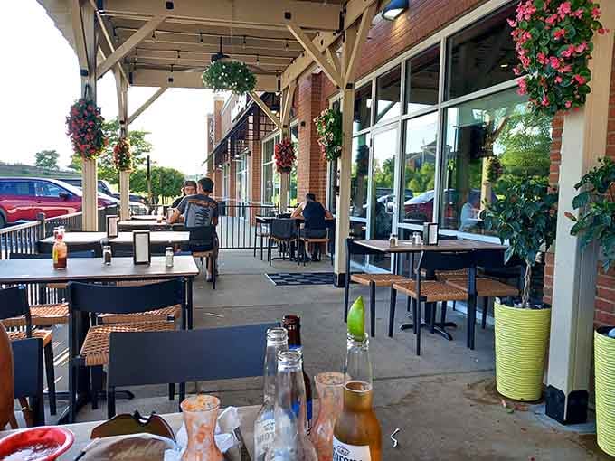 The outdoor patio offers fresh air, hanging flowers, and the perfect spot for enjoying warm evenings with cold drinks.