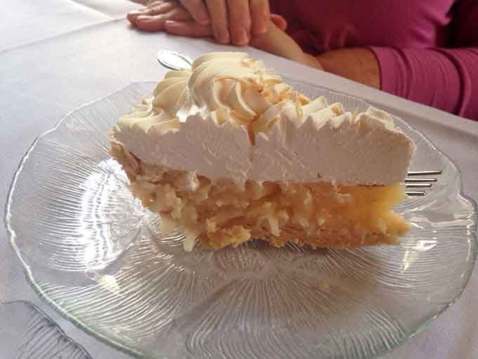 Lemon meringue pie towers with fluffy peaks, offering a sweet finale that'll have you booking your return visit.