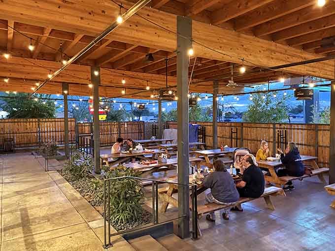 String lights and picnic tables transform outdoor dining into an evening ritual worth repeating religiously every week.