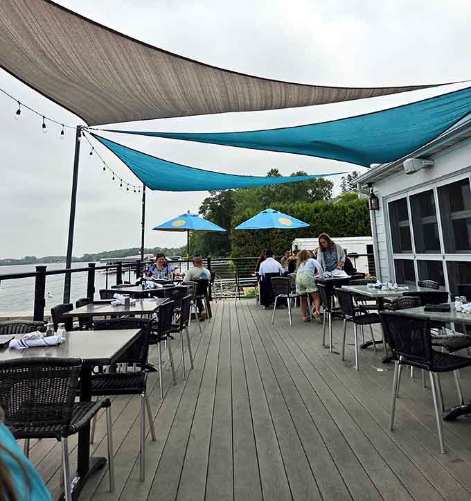 Outdoor seating with shade sails overhead means you can enjoy lakeside views without turning into a lobster yourself.