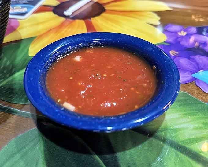 That vibrant salsa in the cobalt blue bowl is your ticket to flavor town, one chip at a time, friend.
