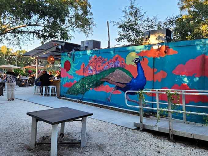 This vibrant peacock mural adds a splash of color and whimsy, reminding you that dining here is about joy.