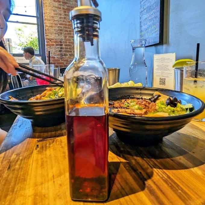House-made chili oil waiting tableside because some folks like their noodles with an extra kick of heat.