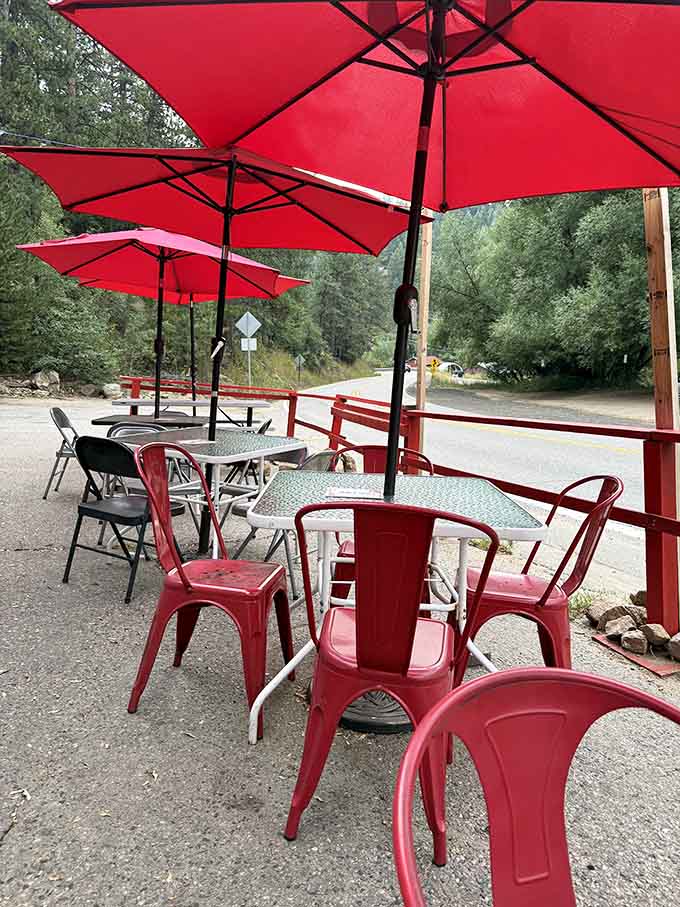 Red umbrellas and mountain views make outdoor dining here feel like a European café vacation.