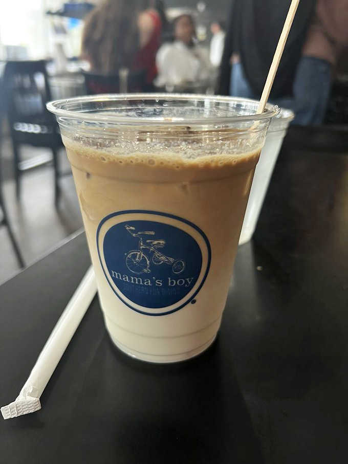 Iced vanilla latte served in a branded cup proves they take their coffee as seriously as biscuits.