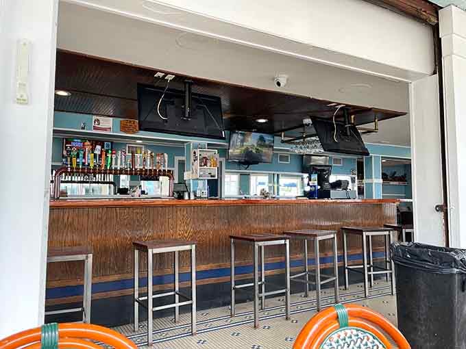 The bar area offers cold drinks and front-row seats to the boardwalk parade of humanity passing by outside.