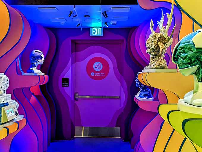 Sculptural heads on wavy pedestals proving that sometimes exit signs lead to the most unexpectedly philosophical moments.