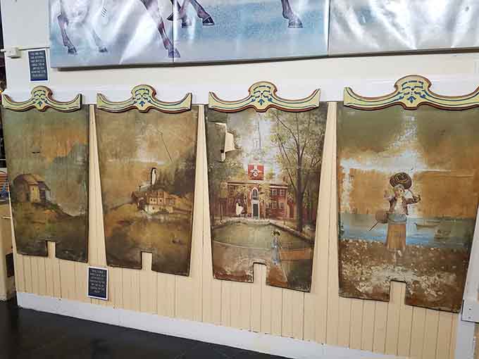 Hand-painted panels that once decorated carousel platforms, each scene telling its own story.