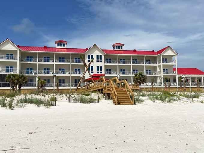 Red roof against white sand and blue sky creates a postcard view that actually exists in real life.