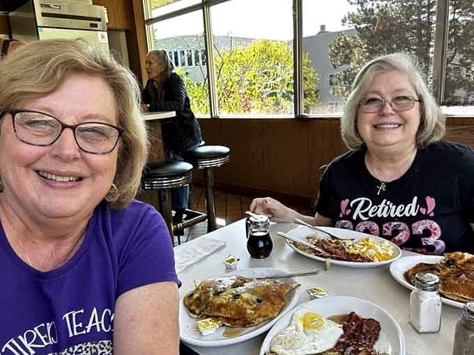 Two happy diners enjoying their meals, proof that good food creates genuine smiles across all generations equally.