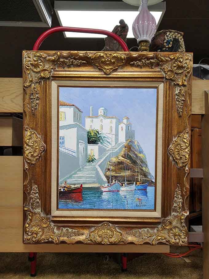 Ornate gilded frame surrounding Mediterranean scenery, bringing European vacation vibes to landlocked Minnesota shoppers everywhere.