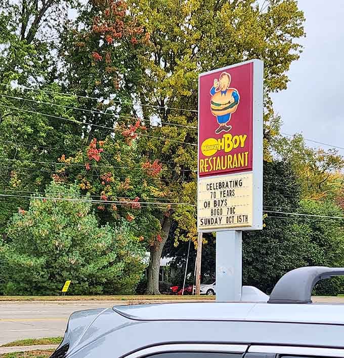 The roadside sign stands tall, announcing celebrations and specials to passing traffic like a friendly neighborhood bulletin board with personality.
