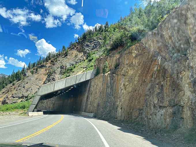 Rock tunnels carved through mountainsides prove that sometimes the most direct route requires moving actual mountains out of your way.