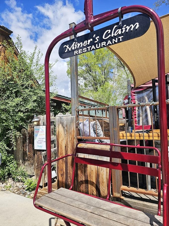 A vintage red ski lift chair repurposed as a charming entrance marker shows this place has personality to spare.