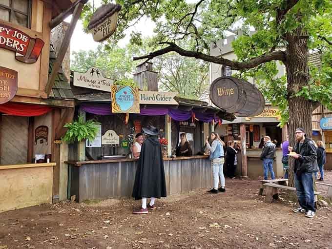 Beverage vendors serve mead and ale from rustic stalls that look straight from a medieval tavern.