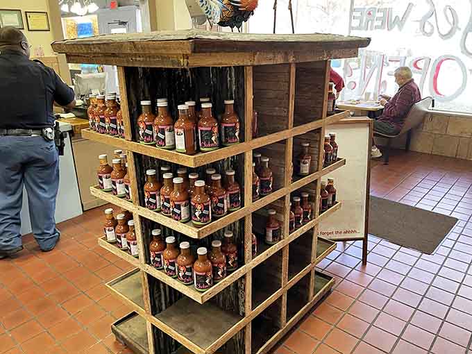 A tower of hot sauce bottles signals serious business: this is where flavor matters and people have strong, spicy opinions.