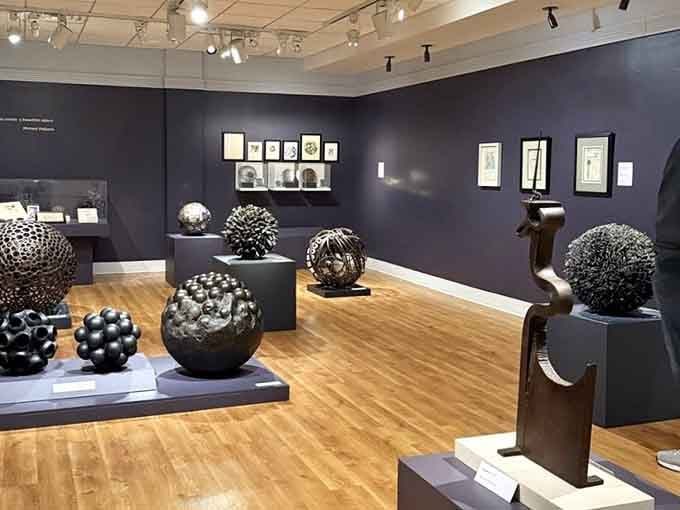 Michael Malpass sculptures that look like they're plotting something interesting in their dark gallery corner.