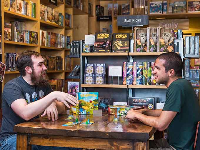 Two players deep in concentration, surrounded by colorful game pieces—this is what quality time actually looks like these days.