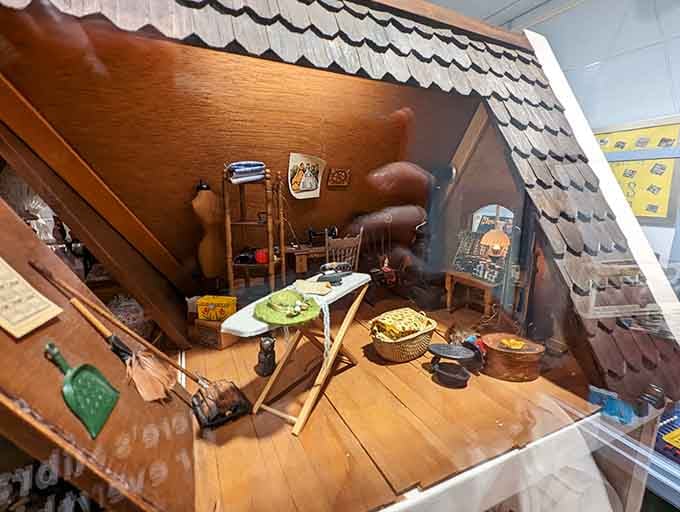 The attic interior reveals miniature clutter and cozy details that make you want to explore every tiny corner.