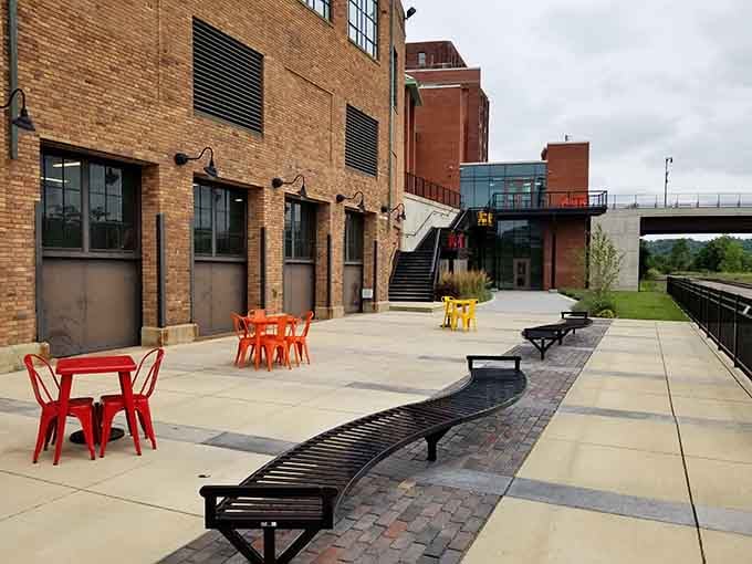 The outdoor patio offers fresh air and colorful seating, perfect for processing all the laughter you just experienced inside the building.