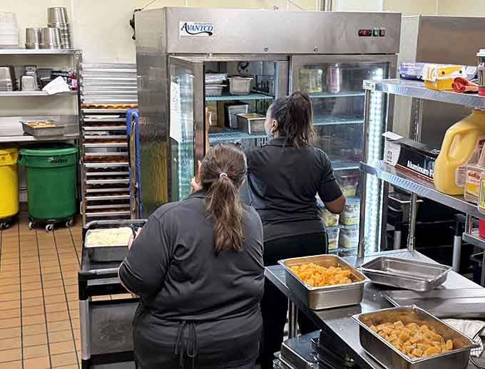 Behind the scenes, the kitchen crew works tirelessly to keep those buffet trays filled with fresh, hot comfort food.