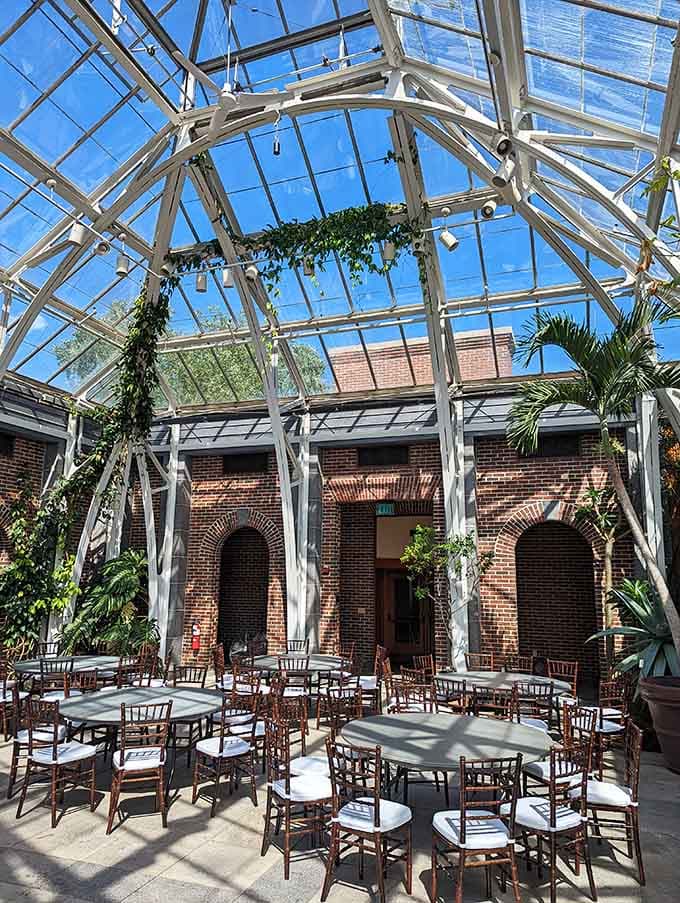 The greenhouse doubles as an event space where brick arches and glass ceilings create an unforgettable backdrop for celebrations.